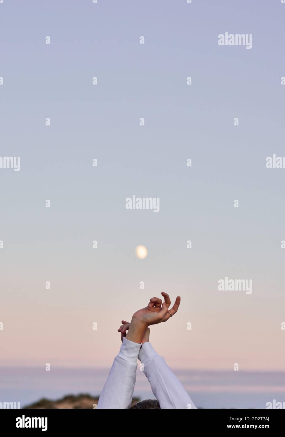 unrecognizable crop female standing with raised arms on background of ...