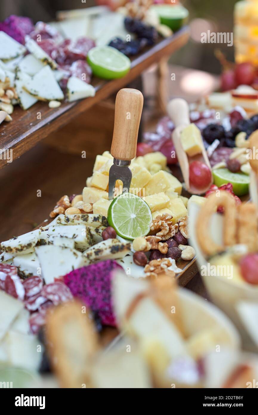 Various palatable appetizers arranged on wooden table full of food for ...