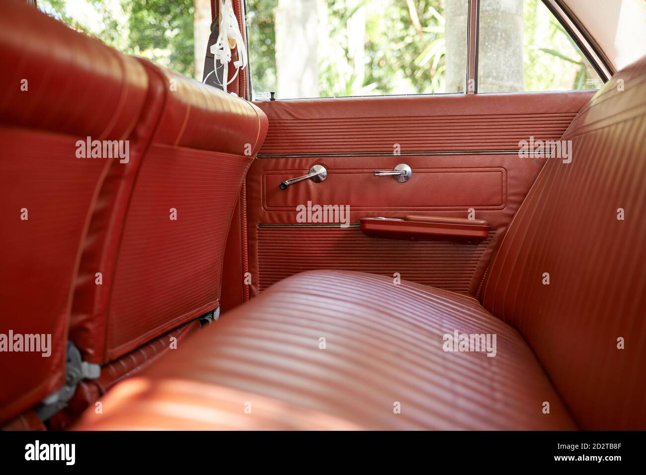 Detail of vintage car with leather door and metal shiny handles parked ...
