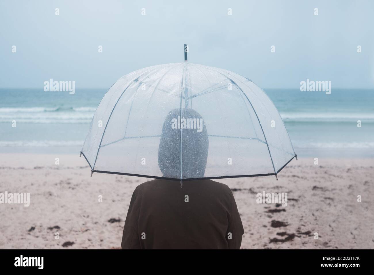 Back view of unrecognizable traveler in raincoat with transparent ...