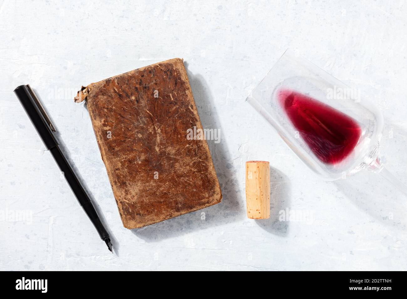 Top view of Wine tasting concept. An old notebook, a pen, a glass of ...