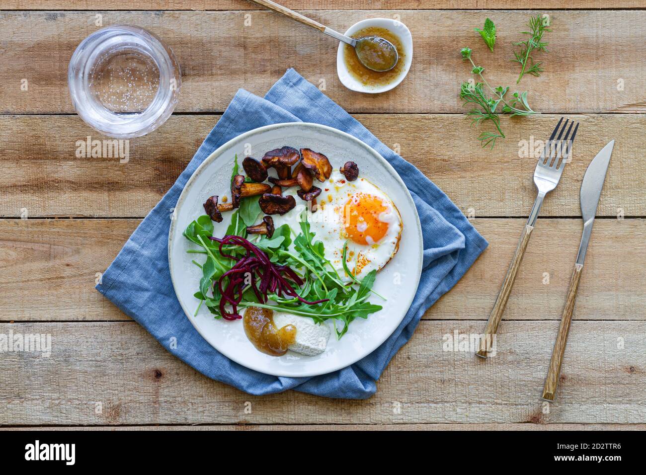 Top view of plate with palatable fried egg served with mushrooms and ...