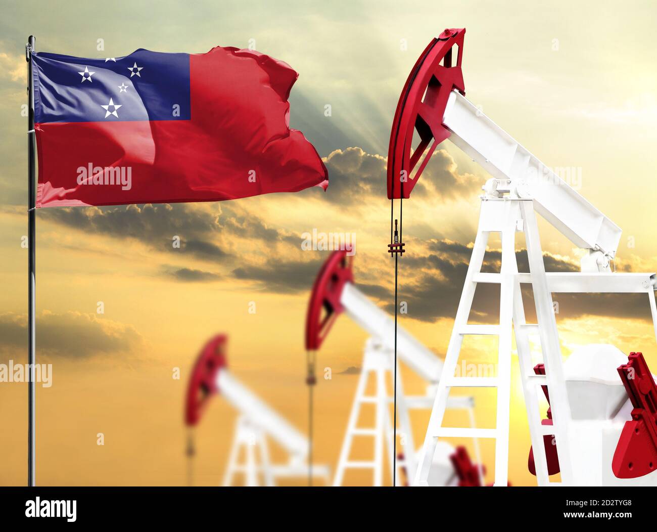 Oil rigs against the backdrop of the colorful sky and a flagpole with ...