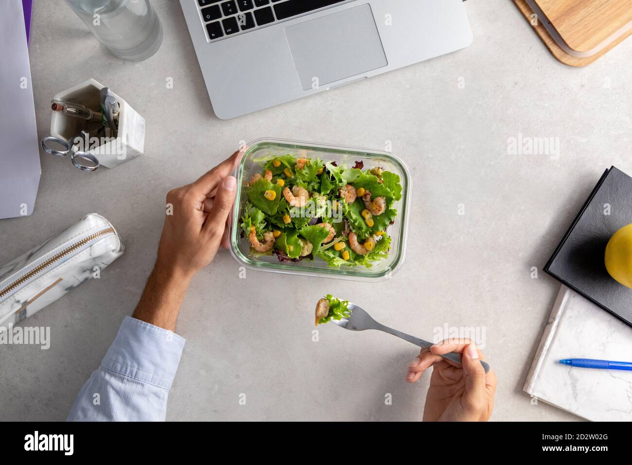 From above of unrecognizable office employee sitting at table in ...