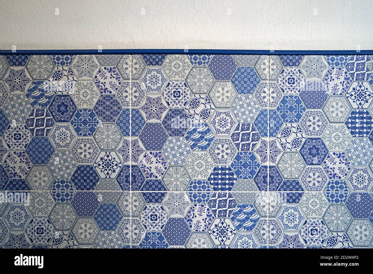 Close up White wall with Blue hexagonal wall tiles texture and surface ...