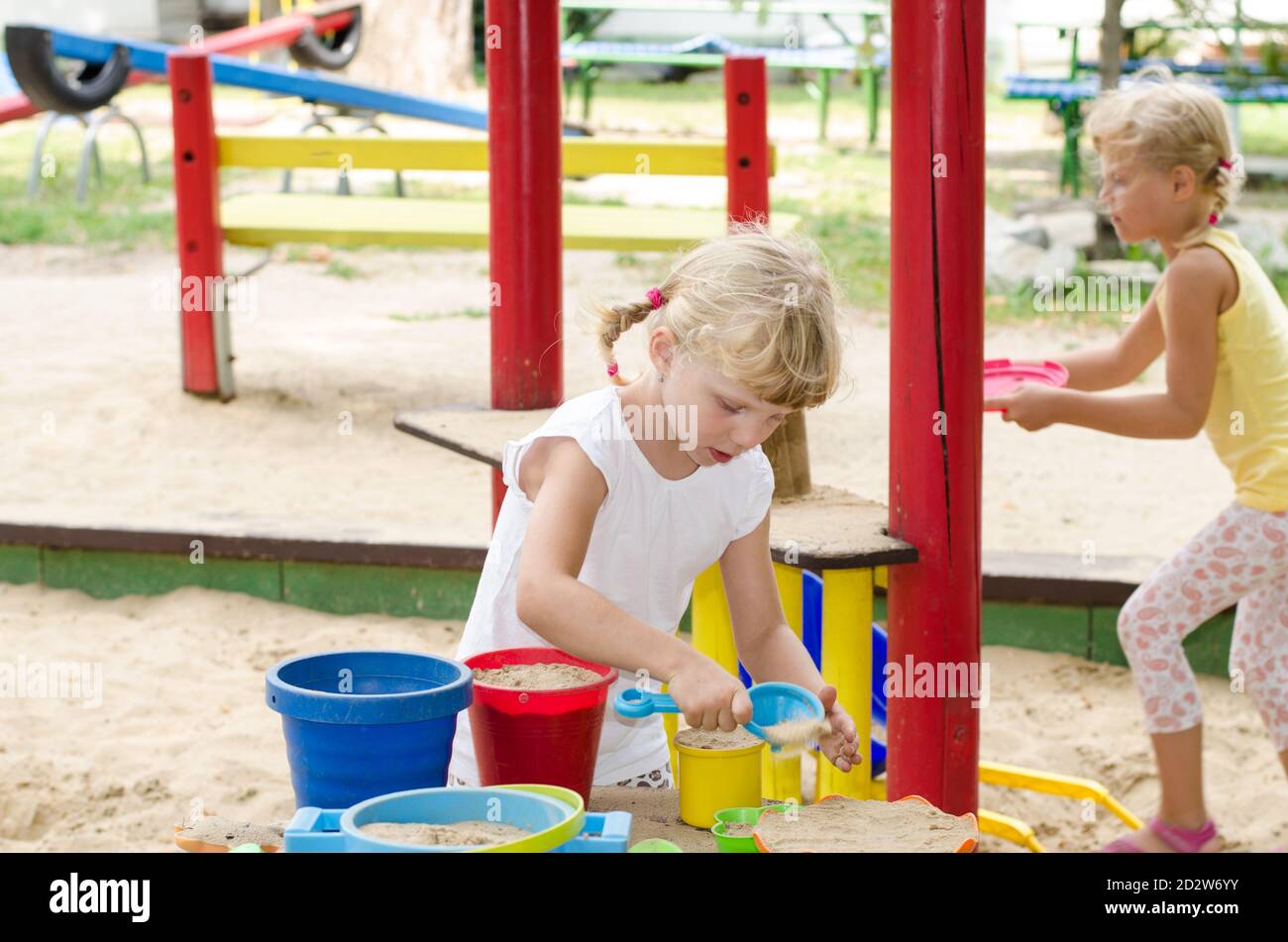 Girl playing in sand pit hi-res stock photography and images - Alamy