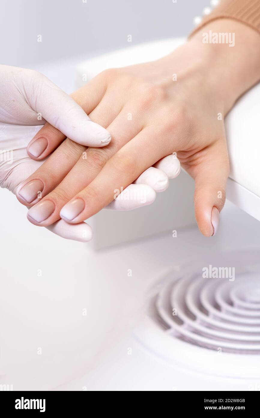 Female hand after manicure in hand of manicure master at nail salon ...