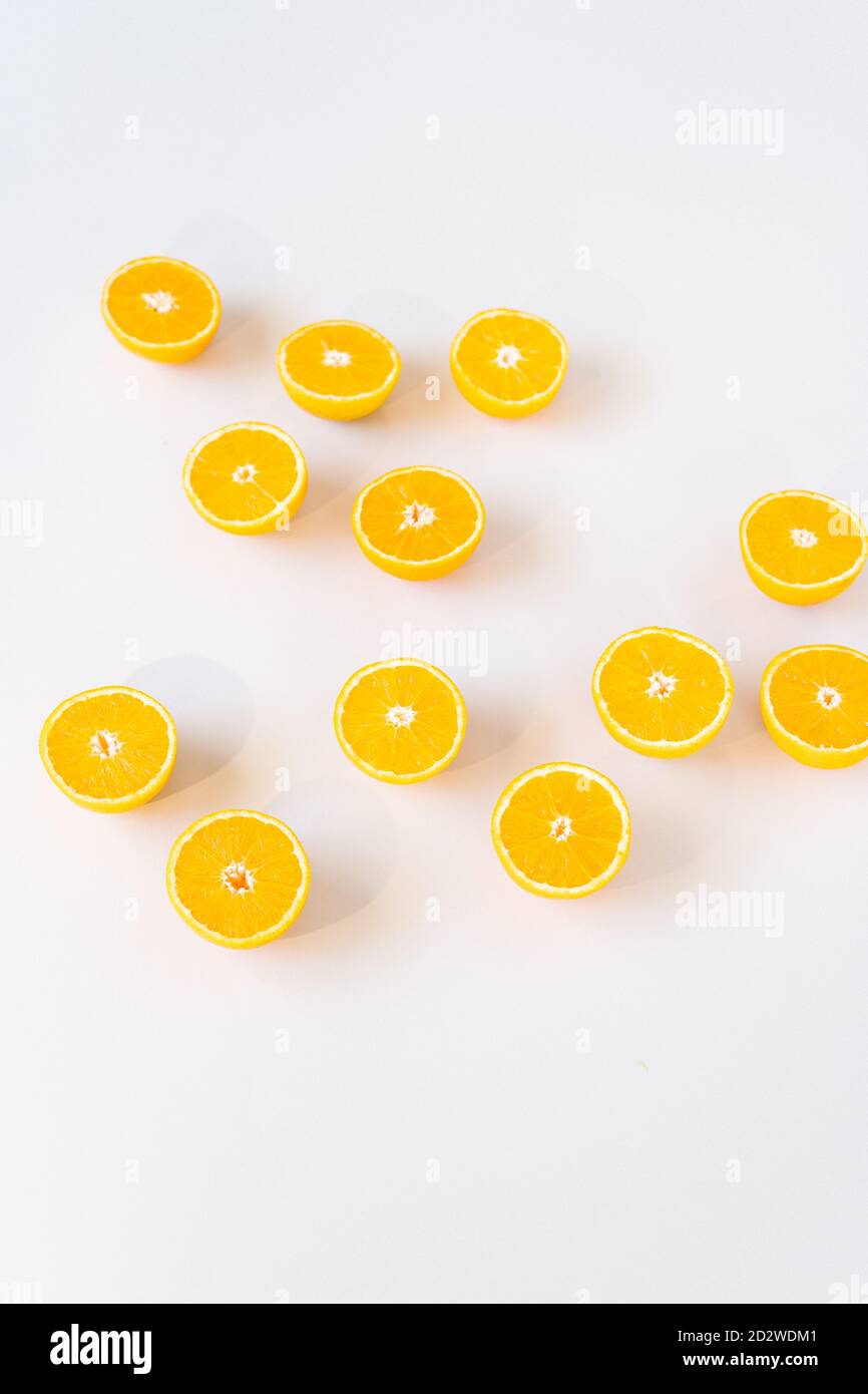 High angle of halves of fresh oranges placed on white background in ...