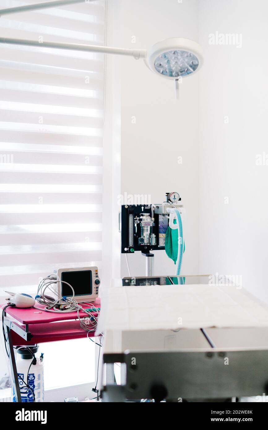 Interior of contemporary operating theater with metal table and gas ...