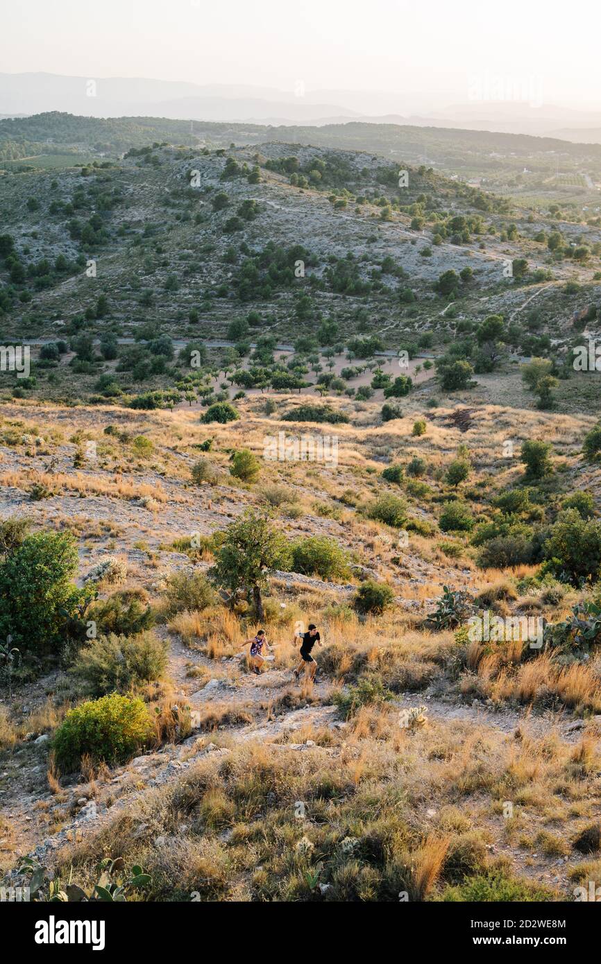 From above view of male and female in sportswear running on narrow path ...
