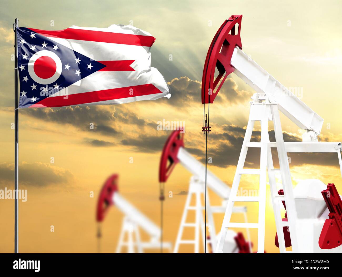 Oil rigs against the backdrop of the colorful sky and a flagpole with ...