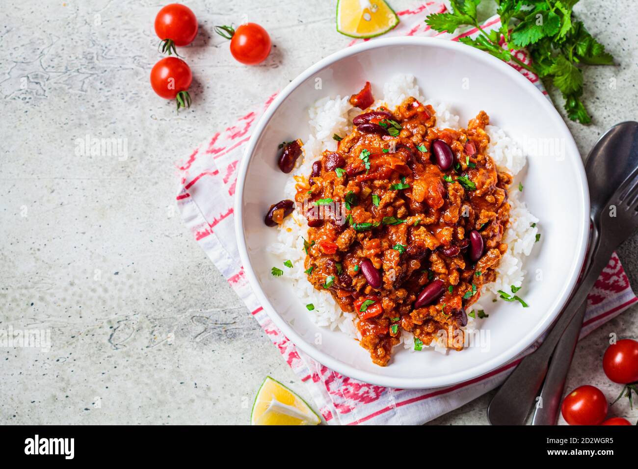 Chili con carne with rice in a white bowl. Beef stew with beans in ...