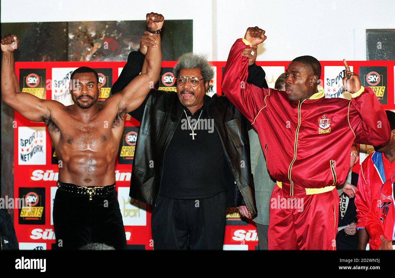 Promoter Don King (cen) holds the arms aloft of WBC heavyweight ...