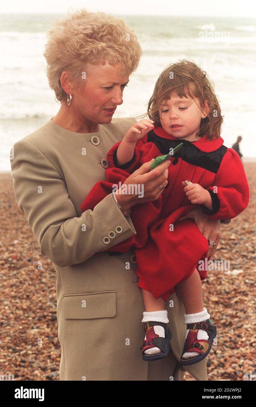 MEP Glenys Kinnock shows a butterfly mine to Angela Cunningham, aged ...