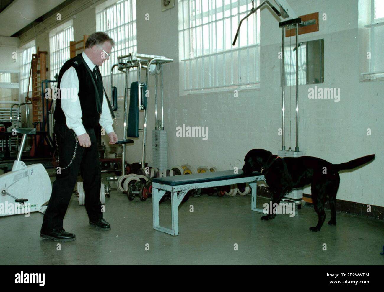 Prison officer Dave Hold carries out a search for drugs in the gym area ...