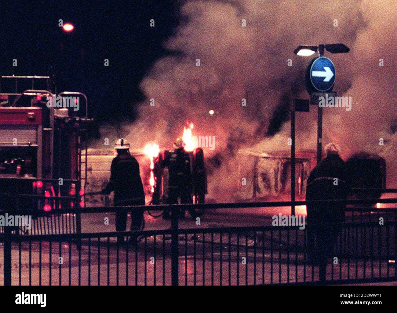 Firemen tackle a car on fire in Brixton town centre, south London ...