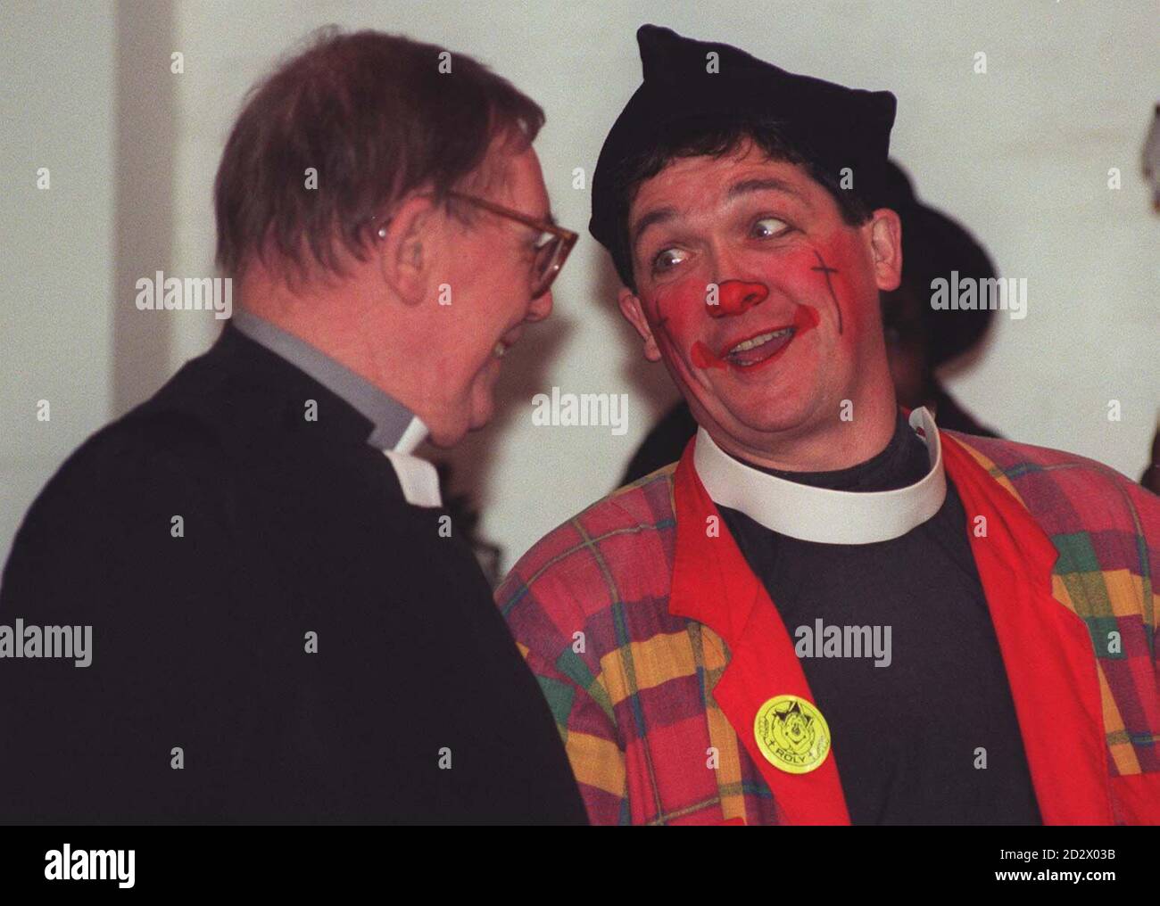 Honorary Priest The Reverend Roly Bain, alias Roly the clown shares a joke with Father Michael ...