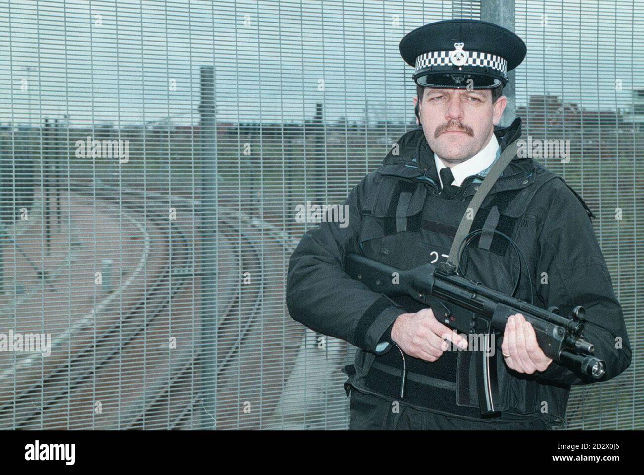 An armed police officer from the Kent police force keeps a guard on the ...