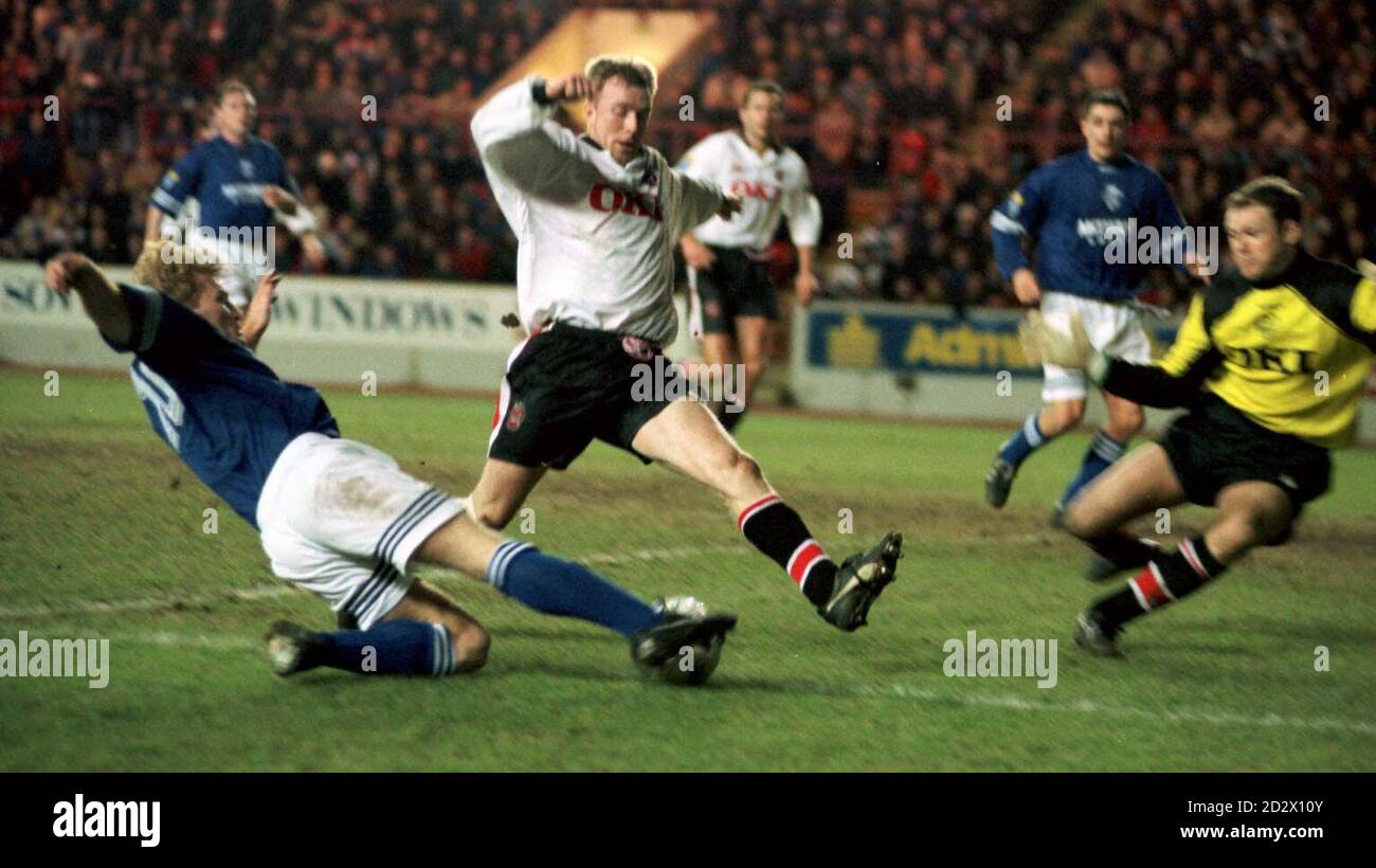 Ranger's Stuart McCall (left) tries to clear the ball from Clyde's ...