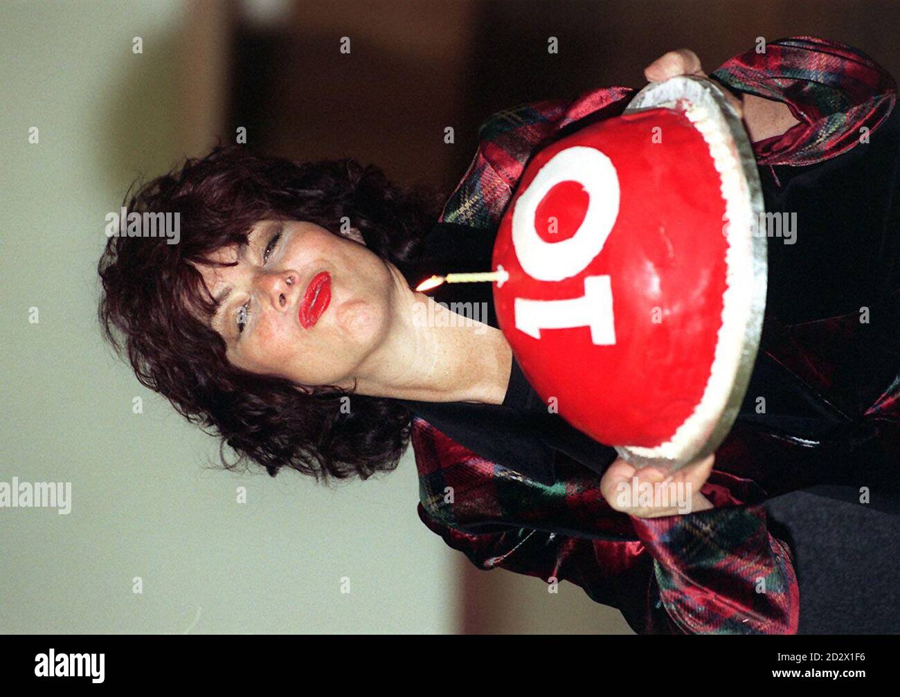 Comedienne Ruby Wax carries a cake in the shape of the famous red nose ...