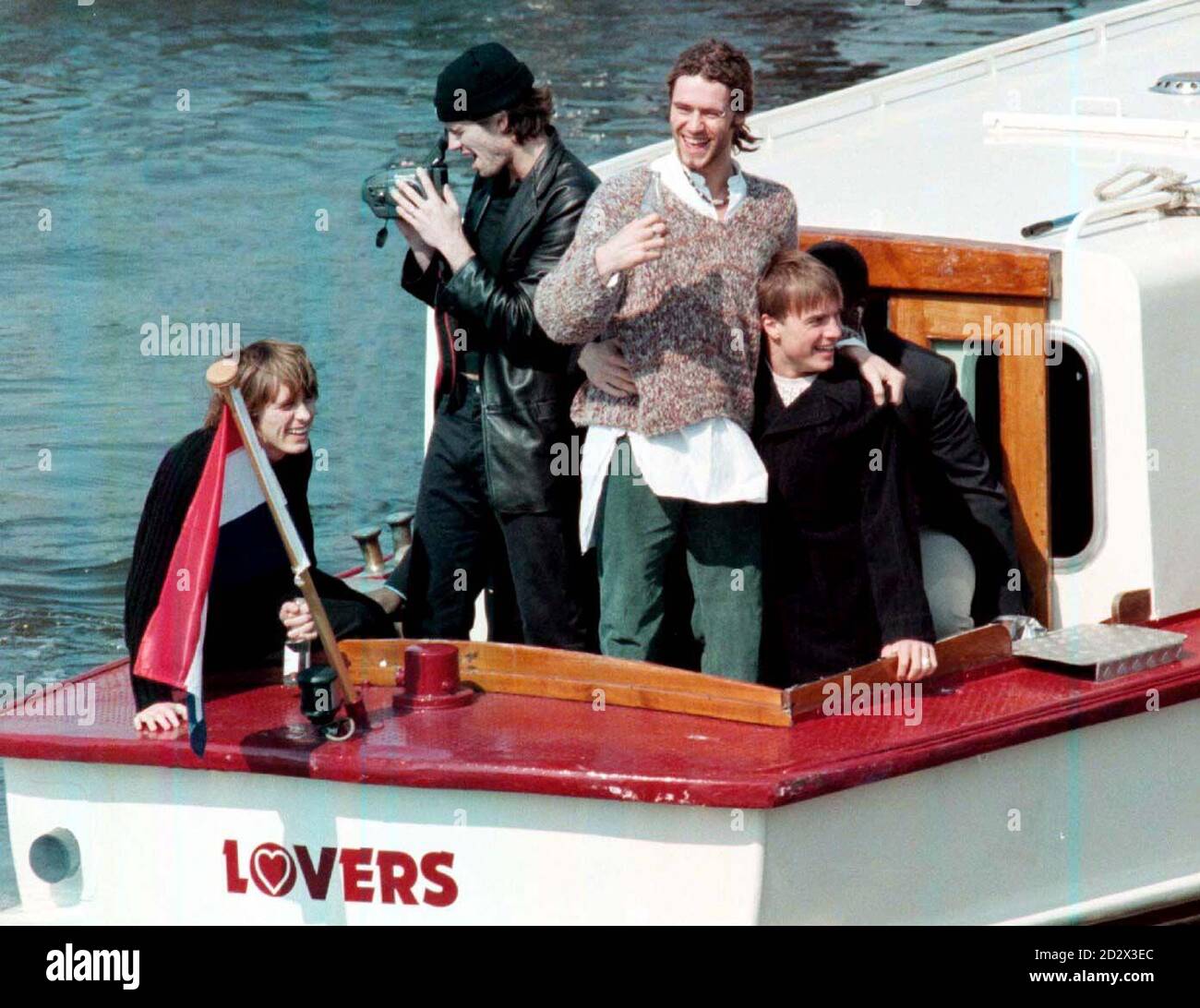 Members of the Manchester band Take That wave to the crowd from their ...