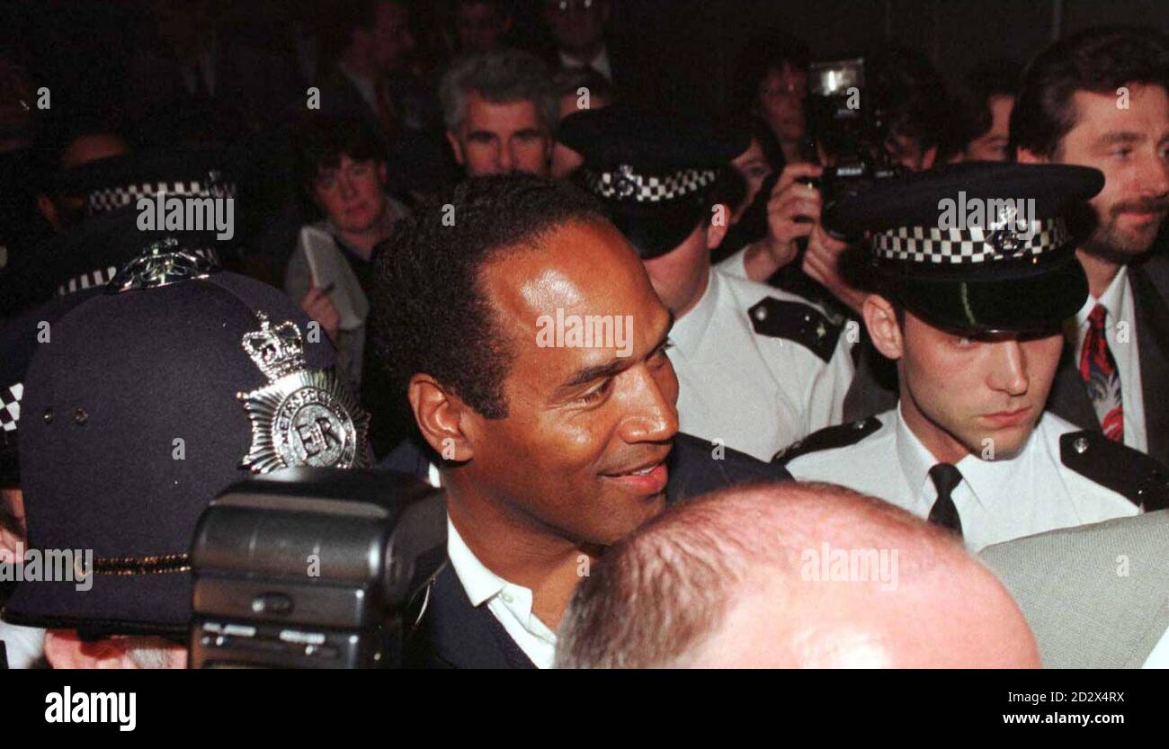 OJ Simpson is surrounded by police and the media at Heathrow airport ...