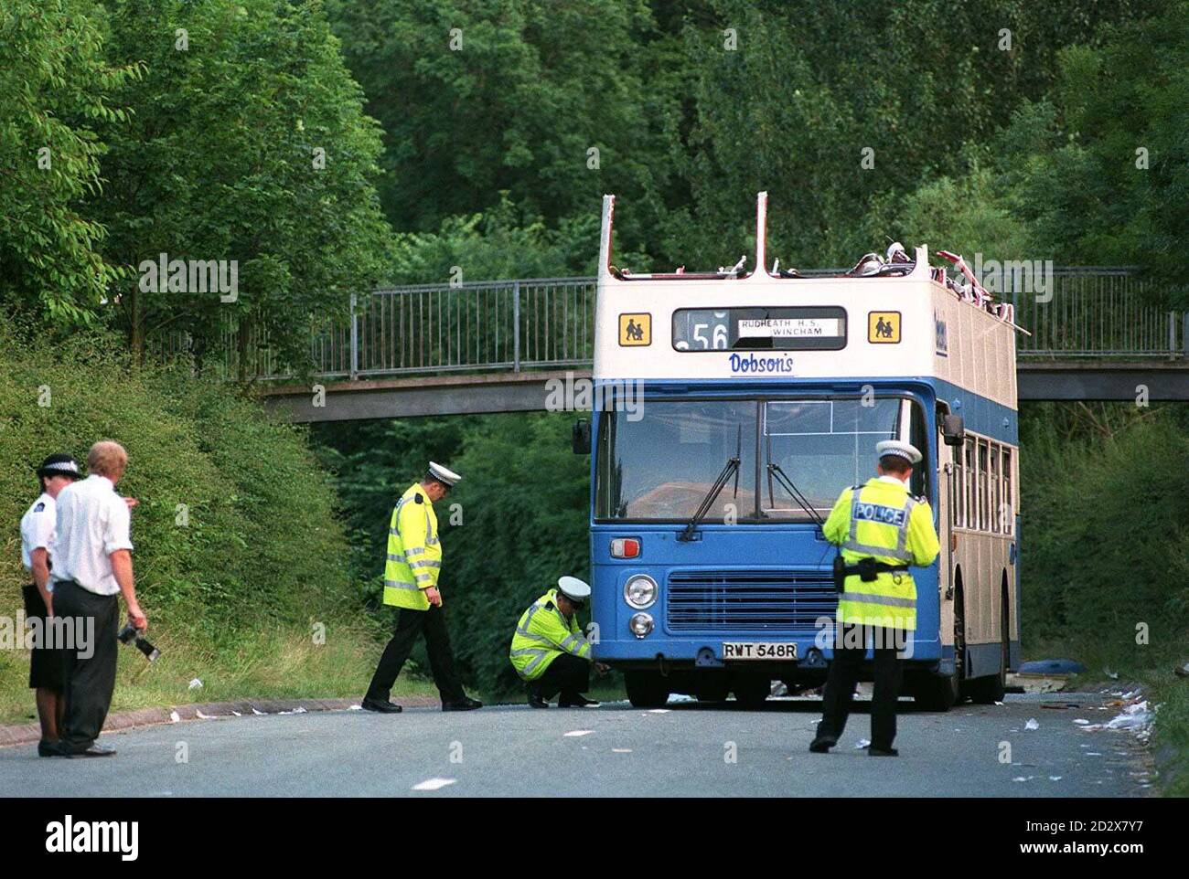 Police check the double-decker school bus after it tried to pass under ...