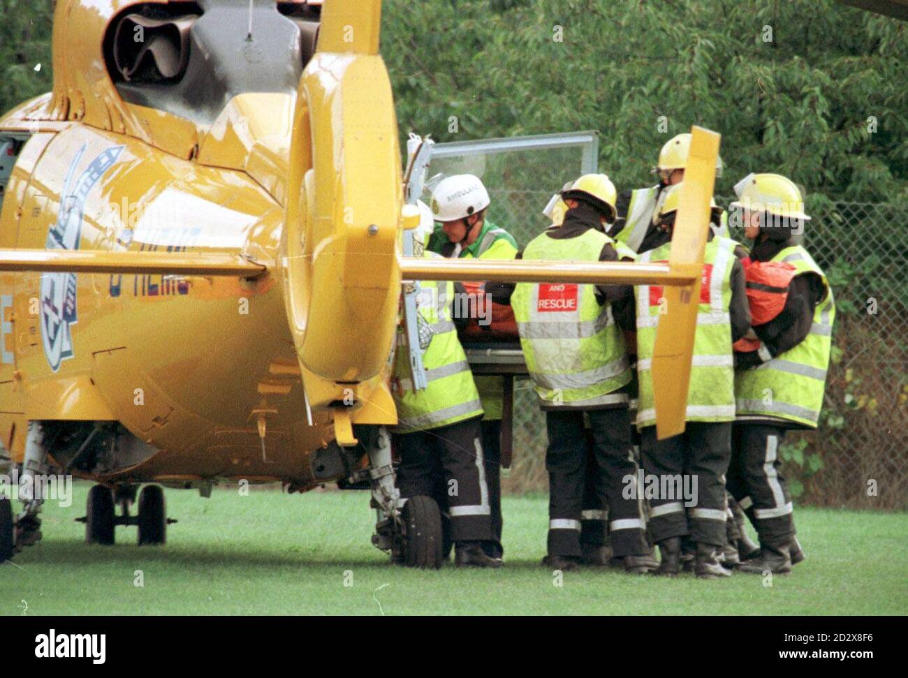 Rescue workers evacuate an injured passenger into the air ambulance at ...