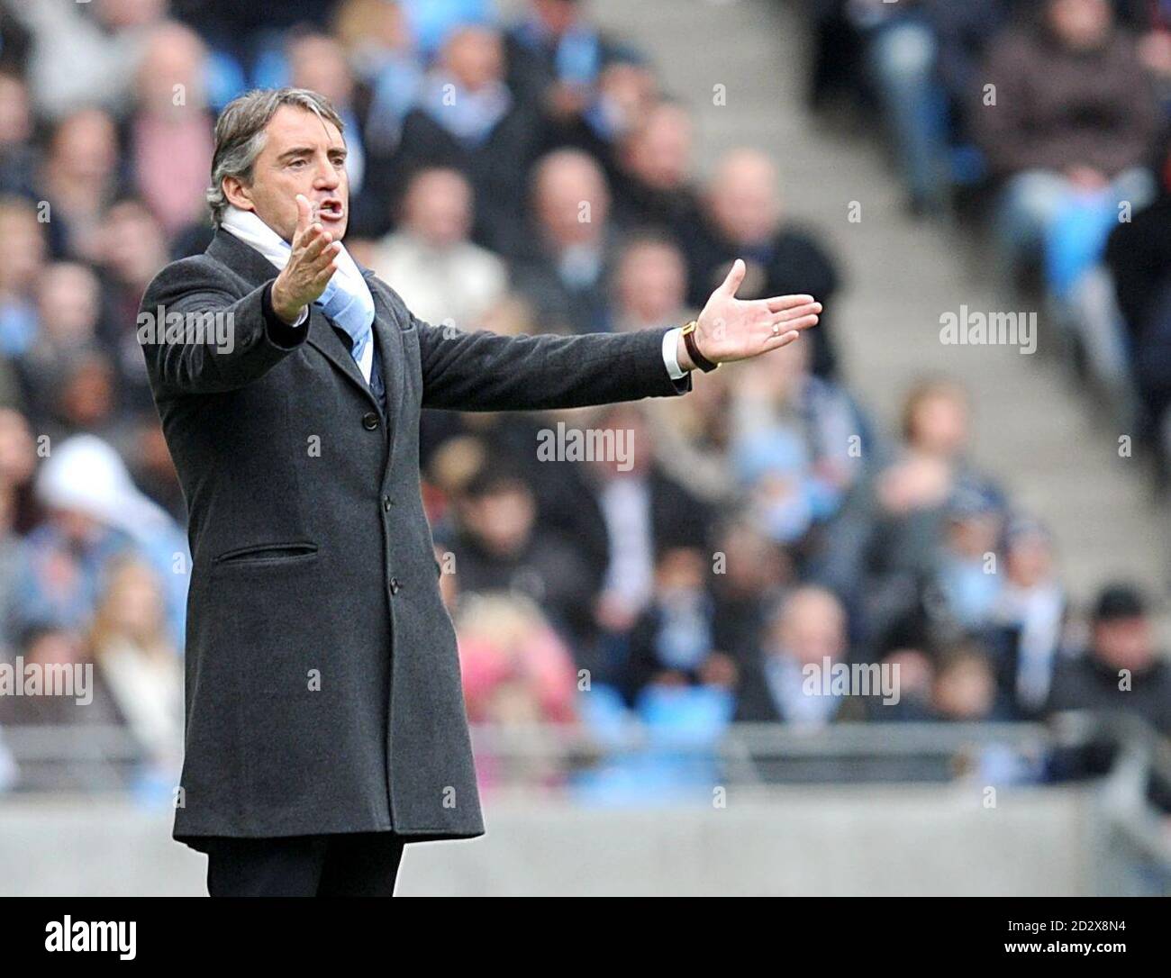 Manchester City manager Roberto Mancini gives instructions on the ...