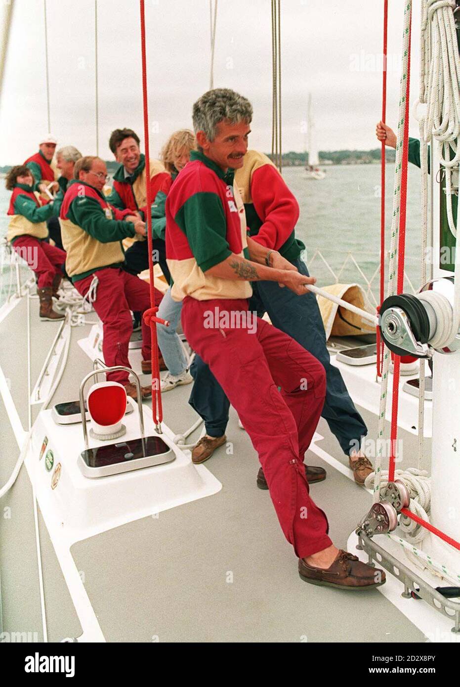 Jim Capstick and some of his fellow crewmembers hoist the mainsail ...
