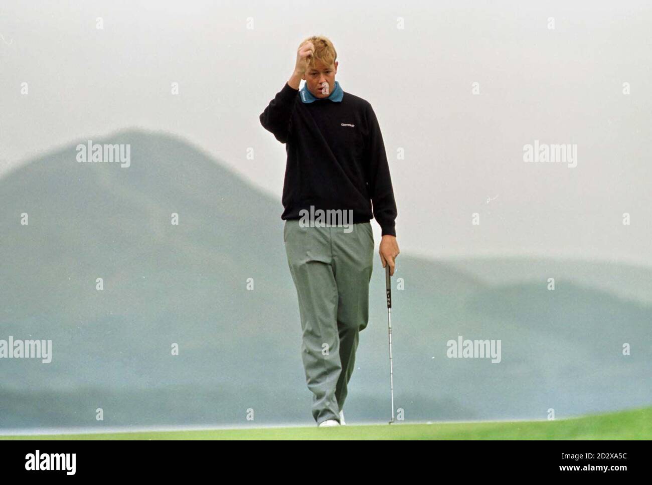 Scotland's Gordon Sherry scratches his head after paring the 6th hole ...