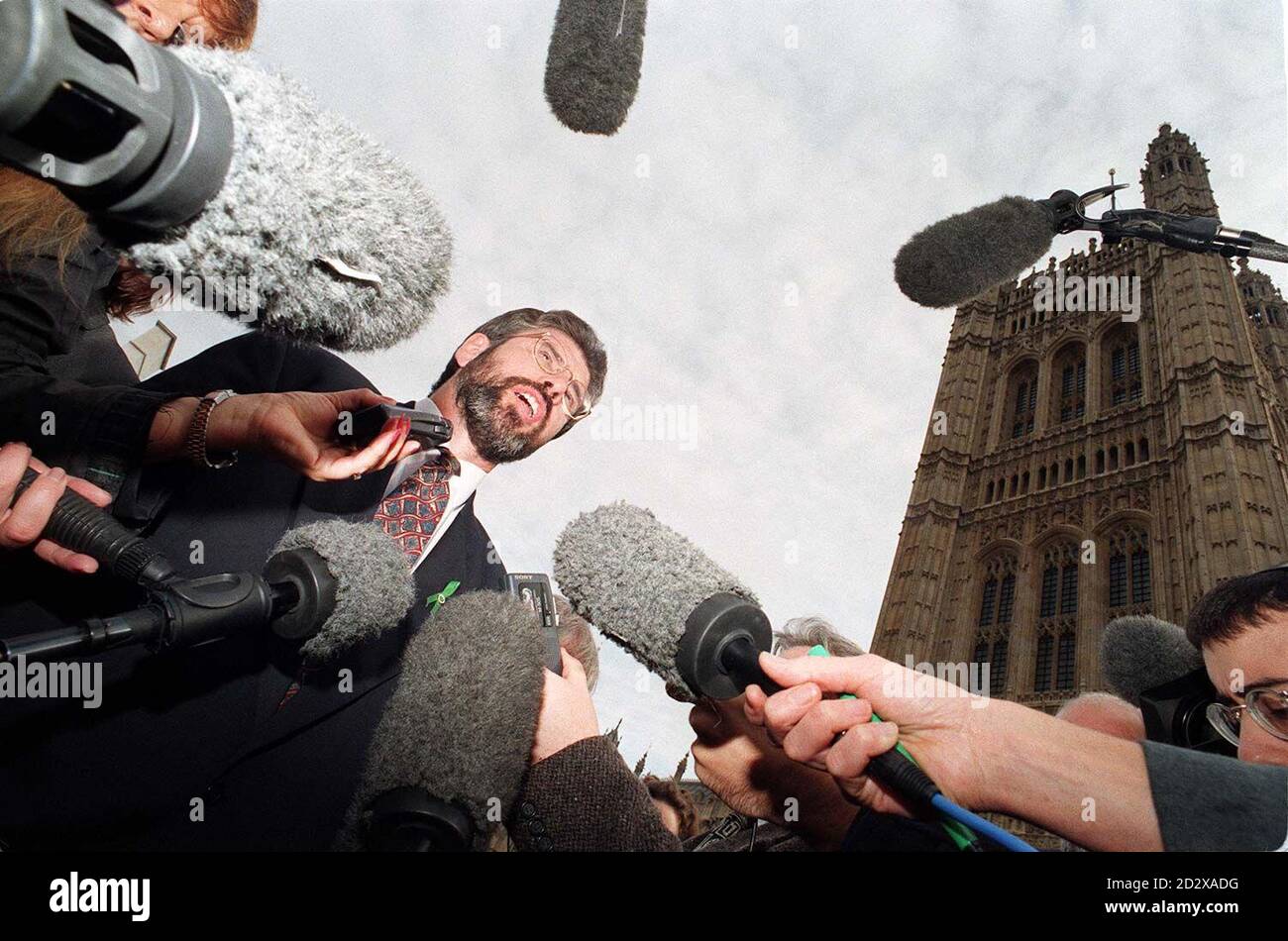 Sinn Fein President Gerry Adams is surrounded by the media as he stands ...