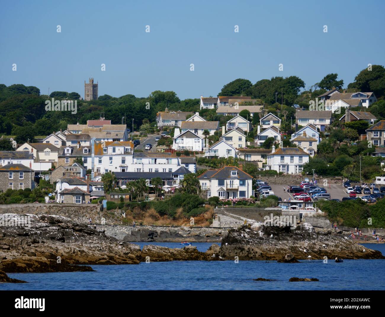 The tower of St Paul's church overlooks the village of Mousehole in ...