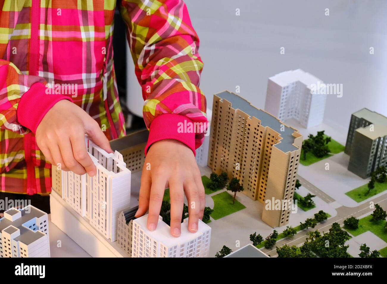 A child builds a model of the house, streets and areas of the city ...