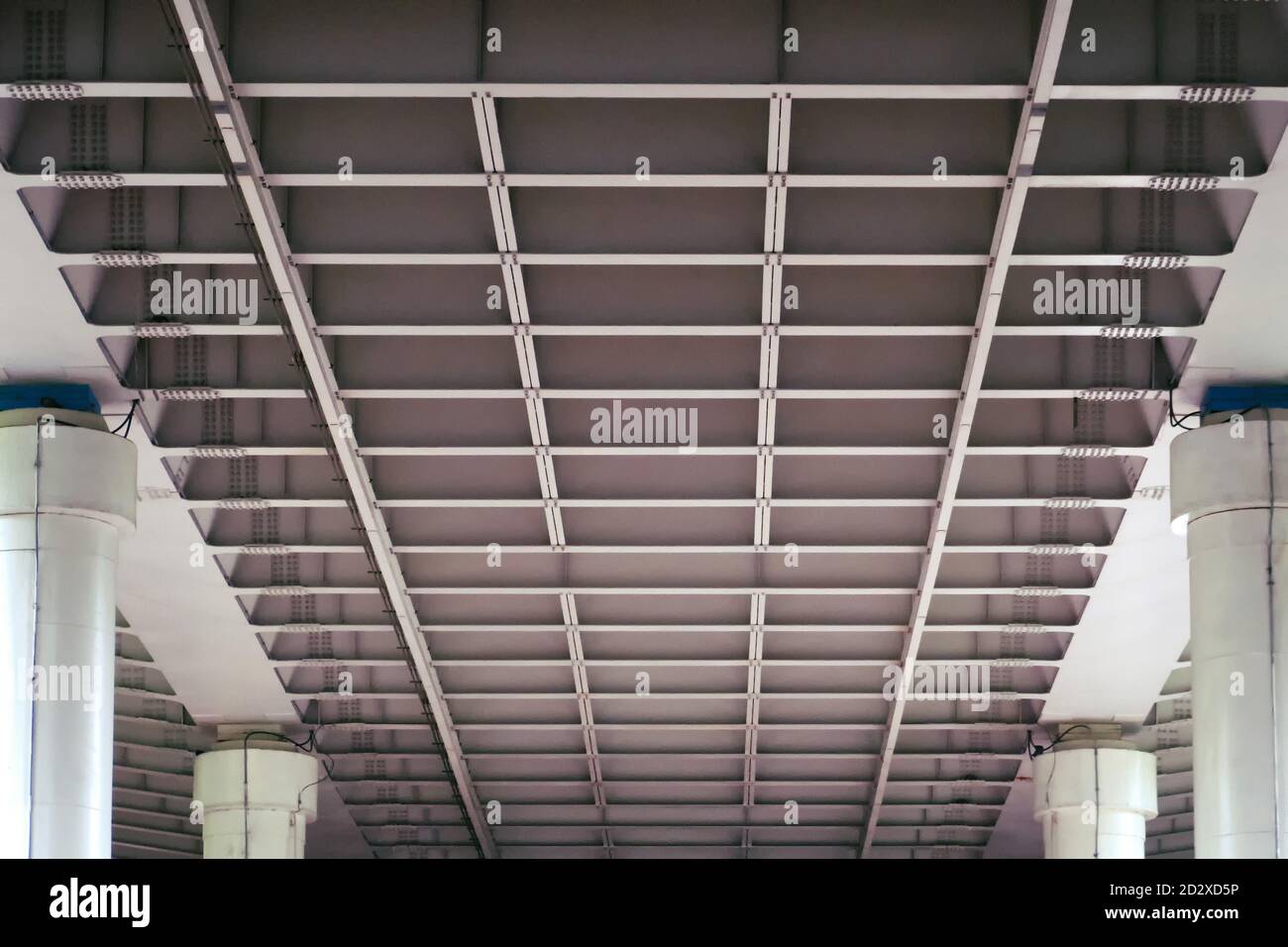 Bottom view of the concrete floors of the big bridge. Square metal ...