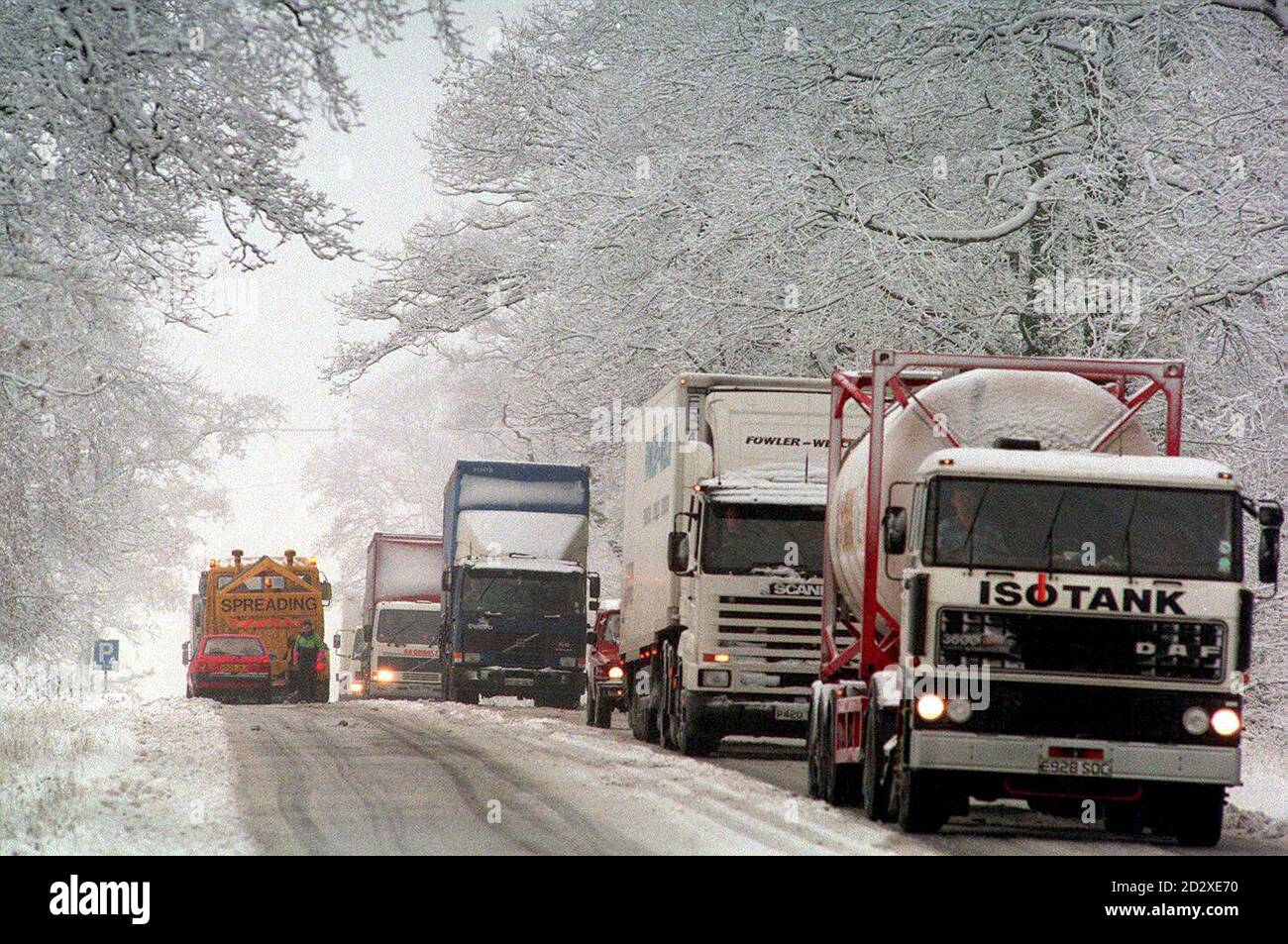 A queue of over 150 vehicles stand trapped in severe snow conditions on ...