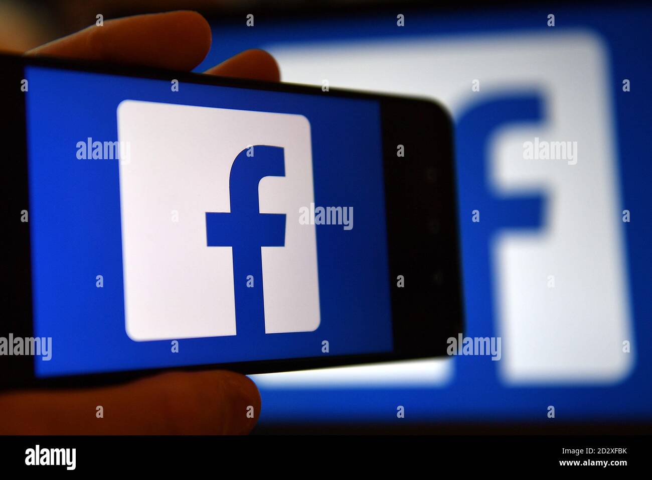 Facebook displayed on screens in London, UK Stock Photo - Alamy