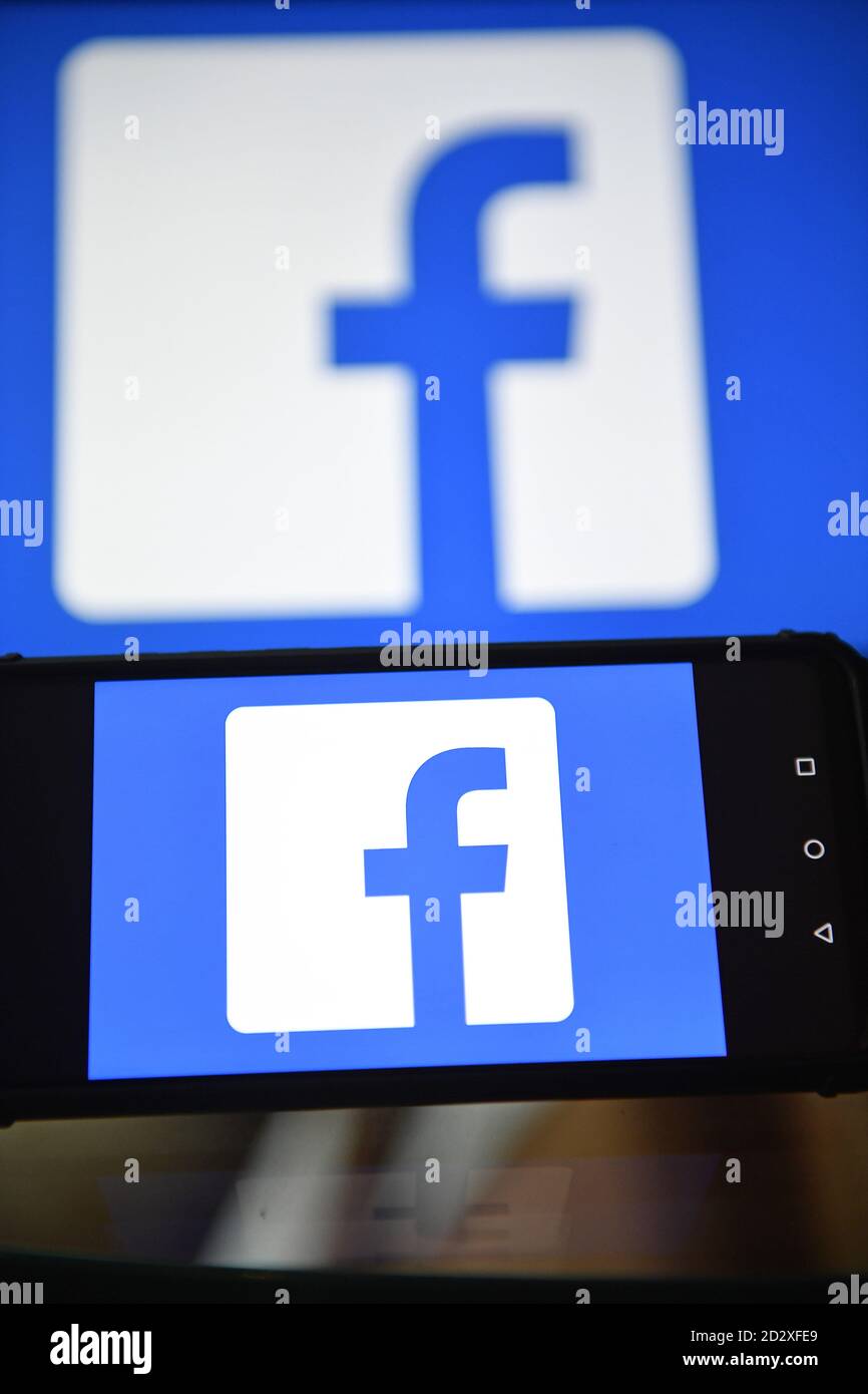Facebook displayed on screens in London, UK Stock Photo - Alamy