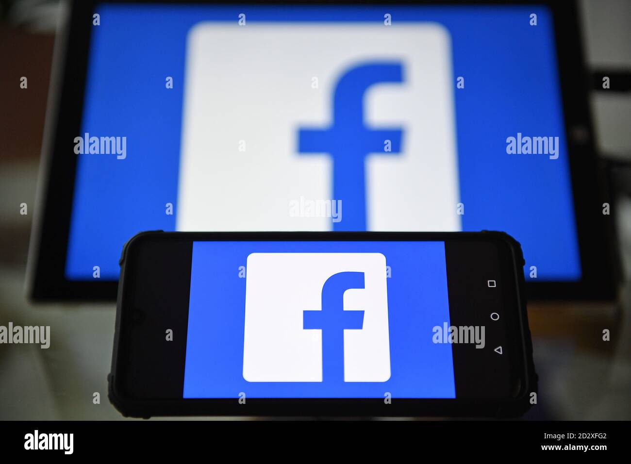 Facebook displayed on screens in London, UK Stock Photo - Alamy