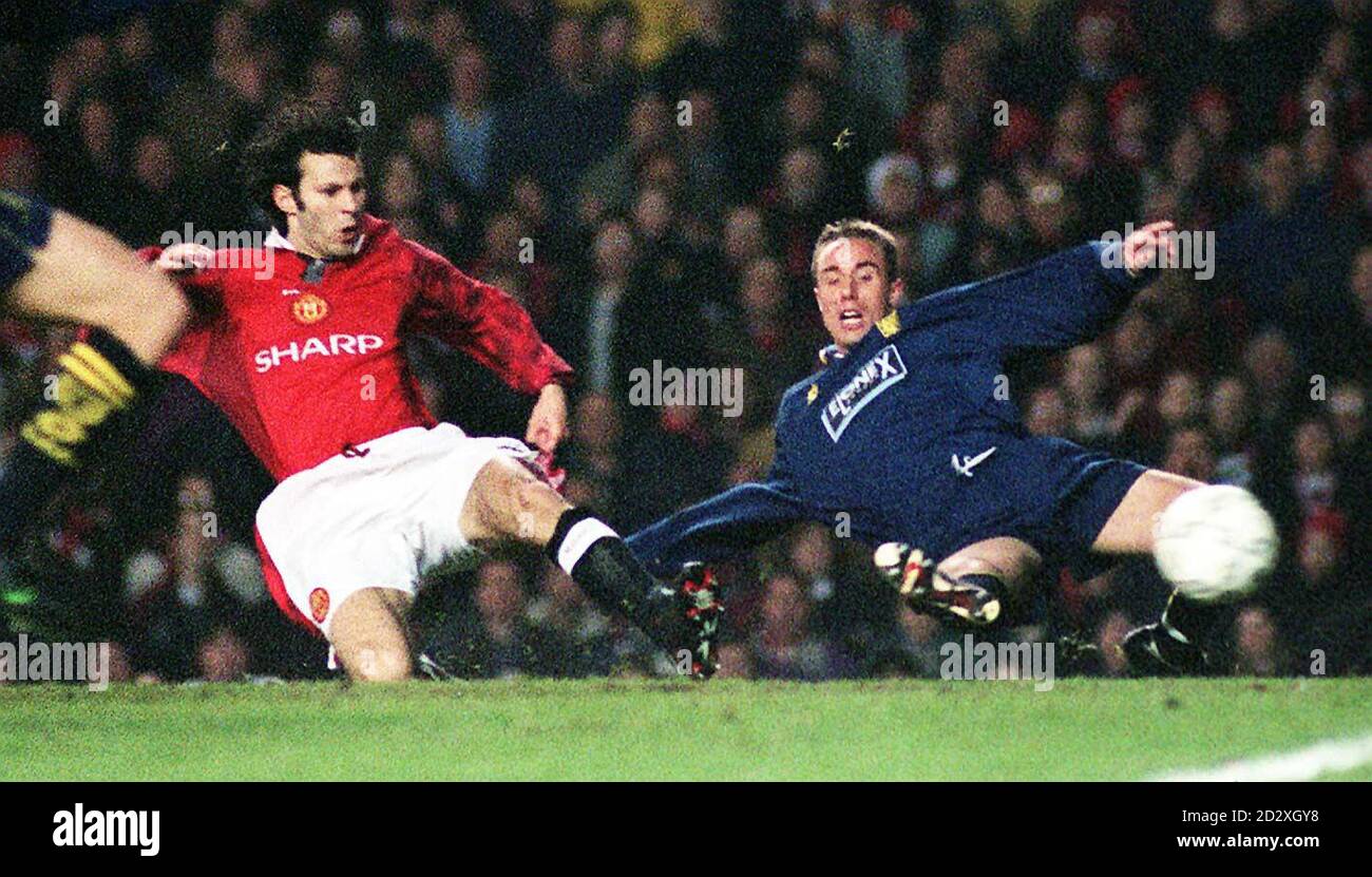 Manchester United's Ryan Giggs (left) gets into a sliding tackle ...