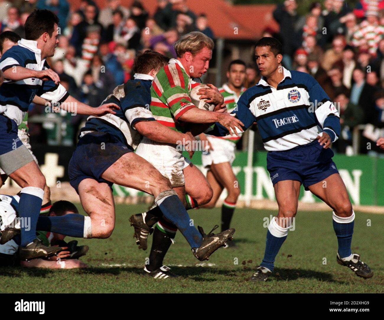 Leicester's Neil Back is tackled (centre), with Bath's Jeremy Guscott ...