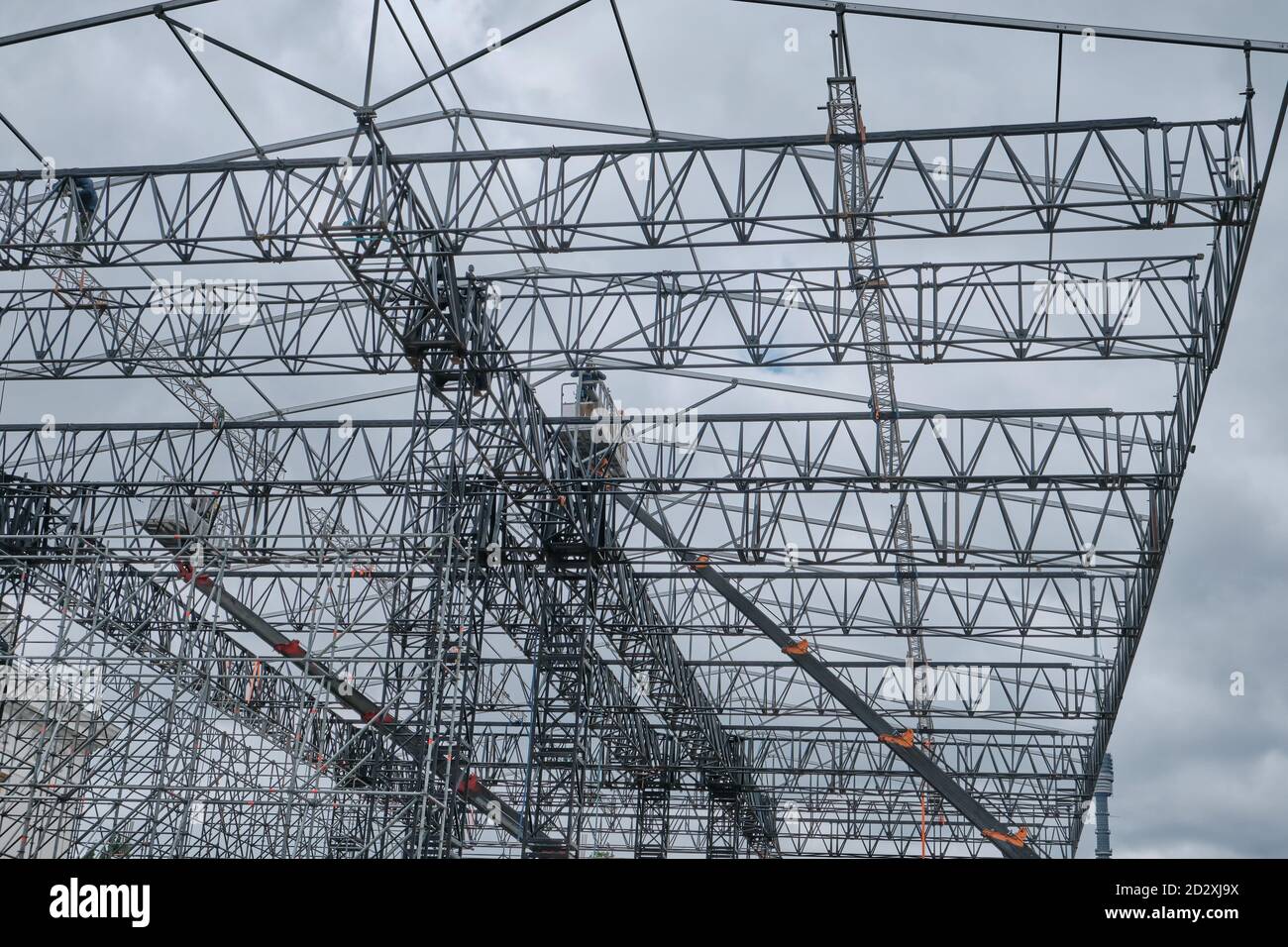 Builders install metal structures for music festival concert stage ...