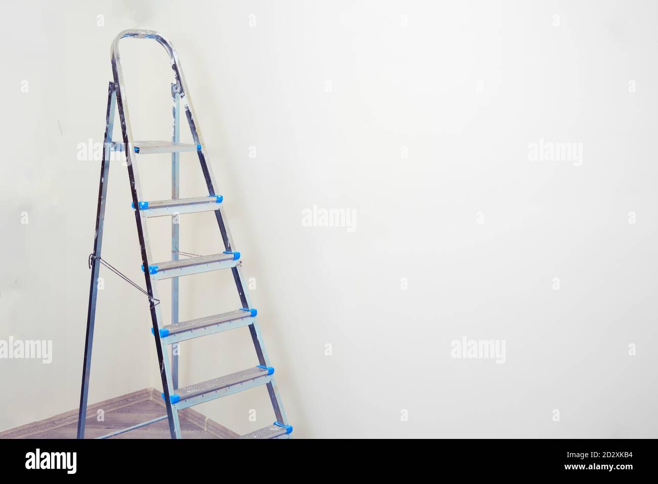 Big metal ladder on the white background of the wall, copy space Stock ...