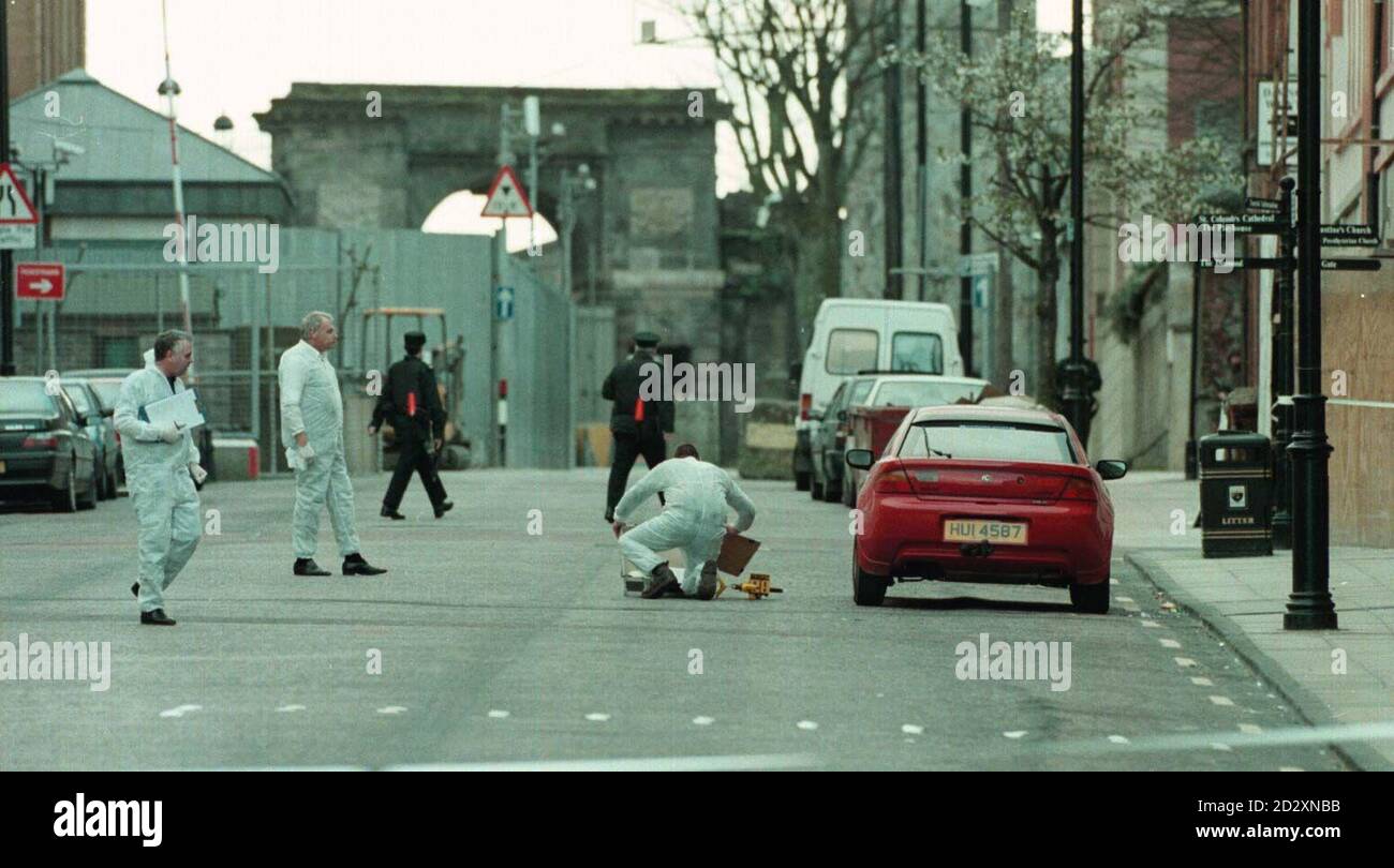 RUC officers and forensic experts examine the area around the ...