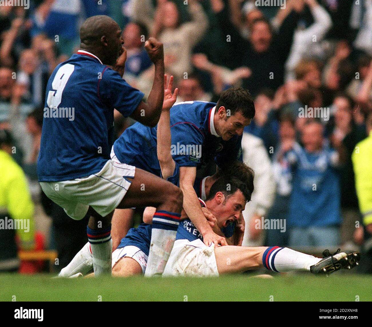 Chesterfield 's Jamie Hewitt is swamped by overjoyed teammates after ...