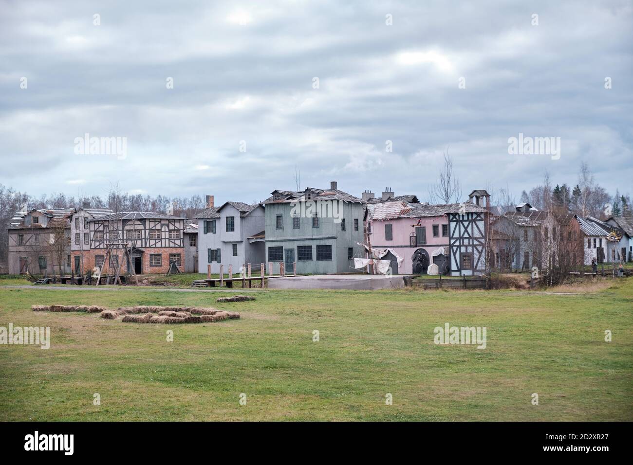 Field with haystacks near the old european town and ancient houses of ...