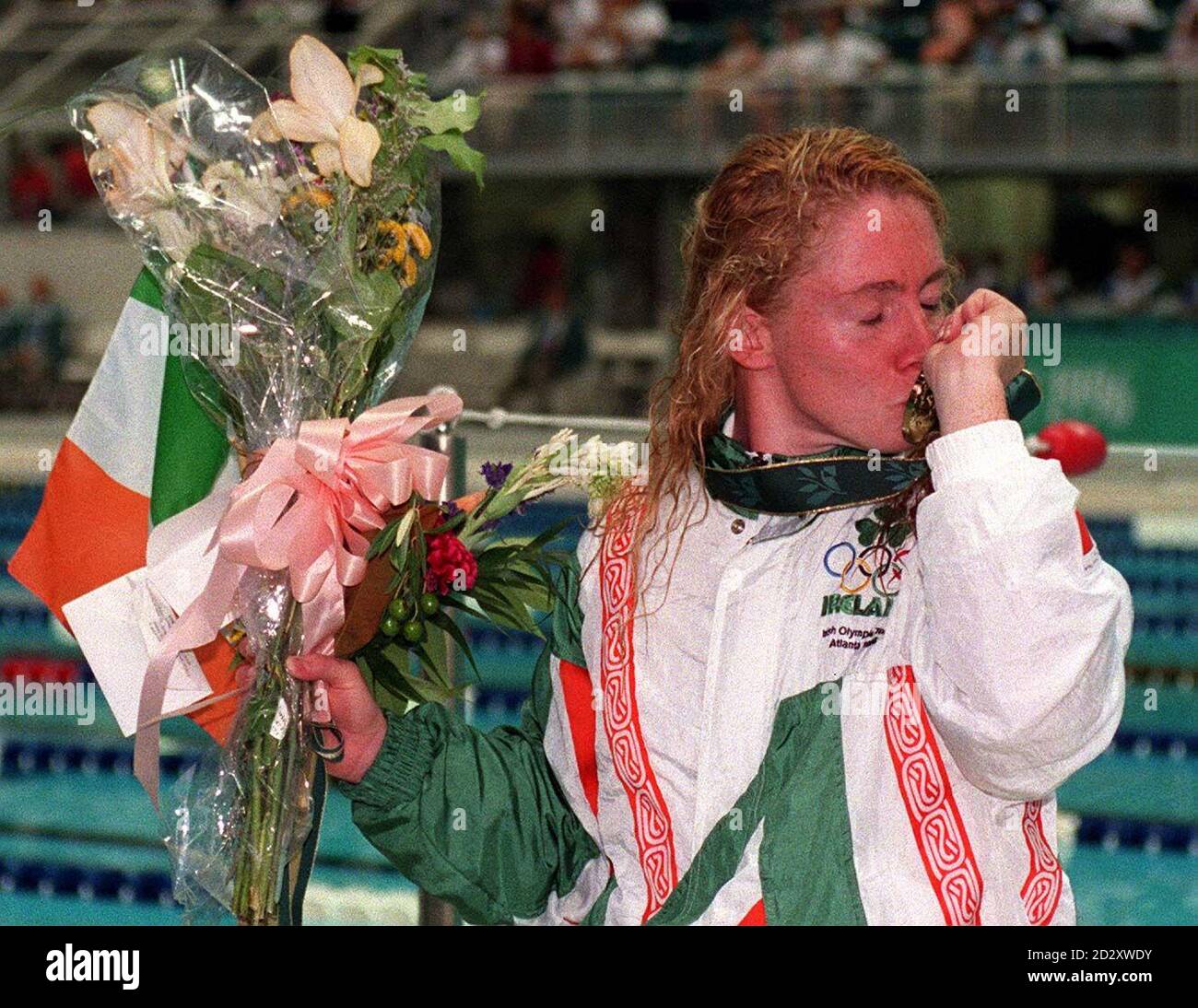 Ireland's Michelle Smith kisses her gold medal at the side of the ...