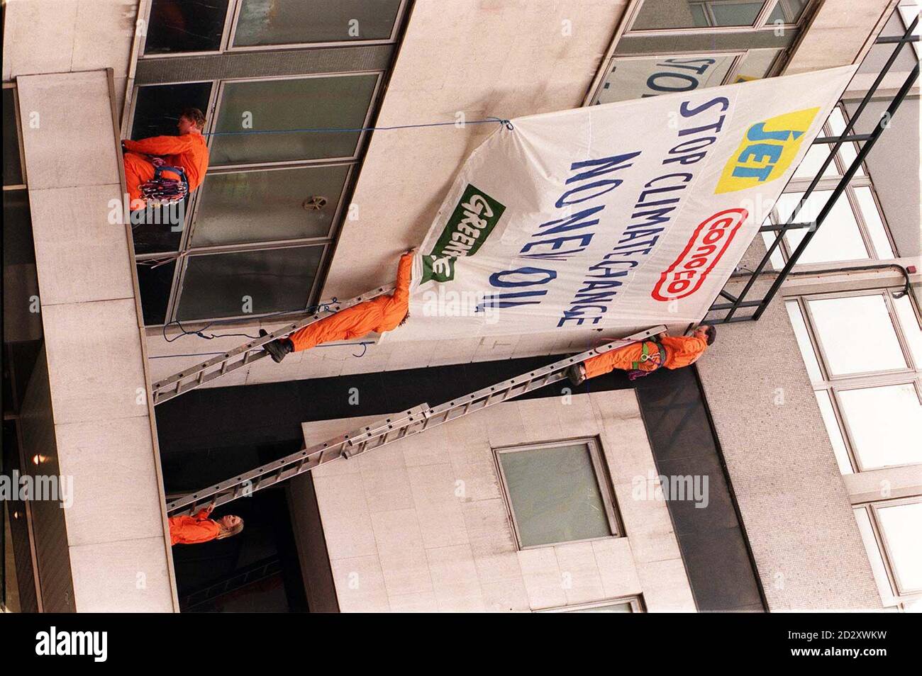 Greenpeace activists attach a banner to the walls of Conoco Oil's ...