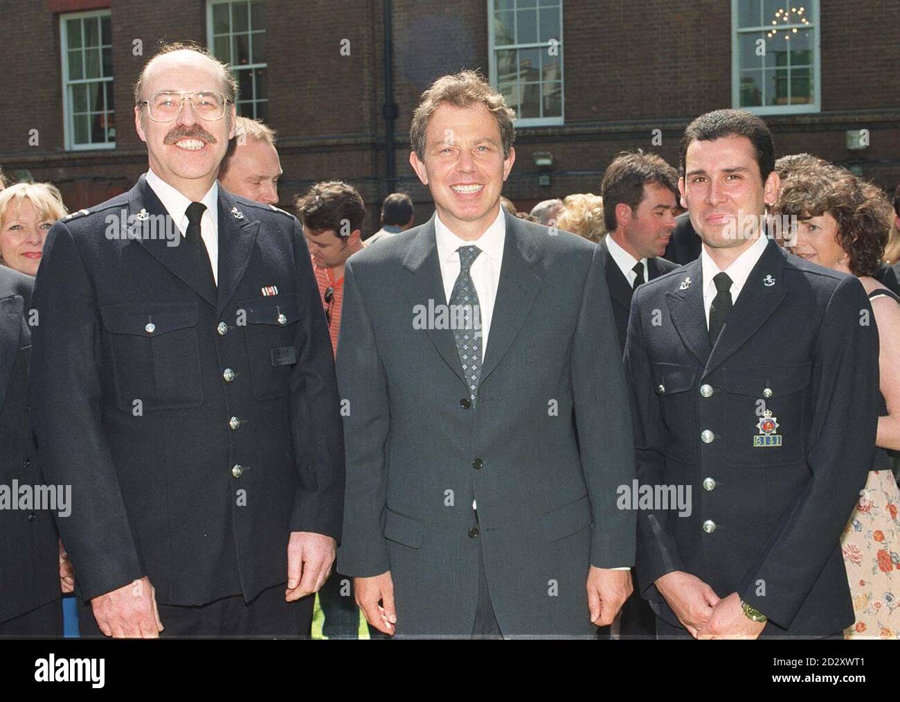 Prime Minister Tony Blair is flanked by SO Michael Downes and PC Alan ...