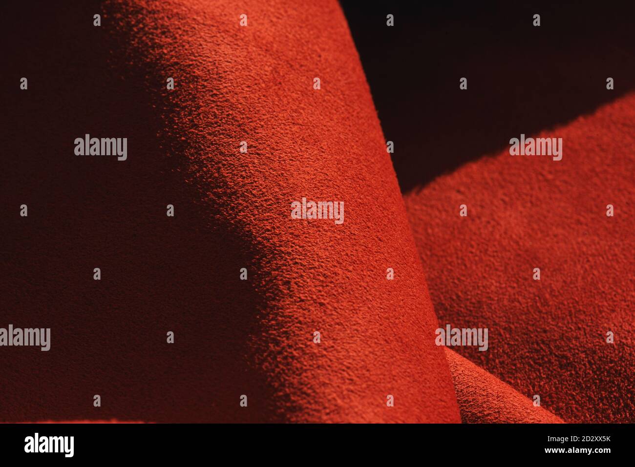 Red matte background of suede fabric, closeup. Velvet texture of ...